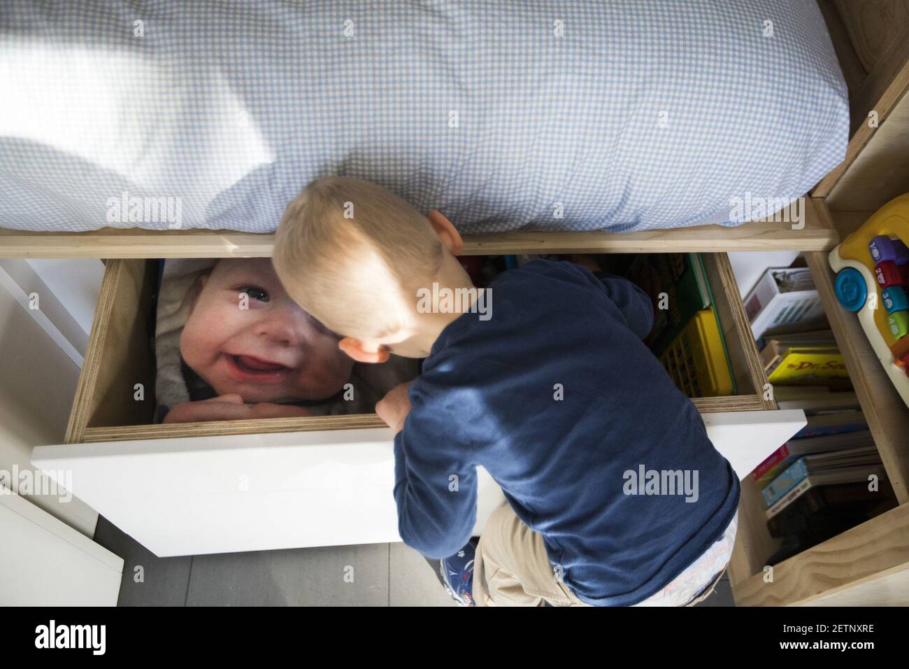Matthew Mikkelson opens his toy drawer, which is nestled under the twin ...