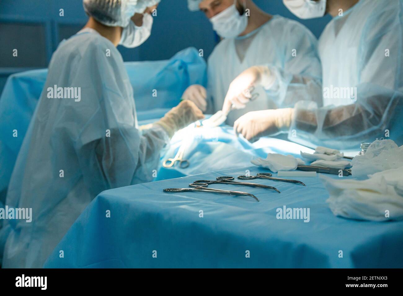 An international team of doctors performs a complex surgical operation ...