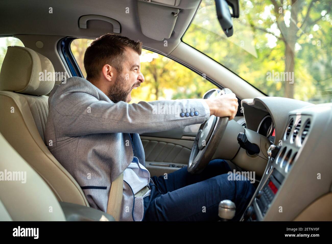 Angry guy boiling with rage driving through the woods Stock Photo - Alamy