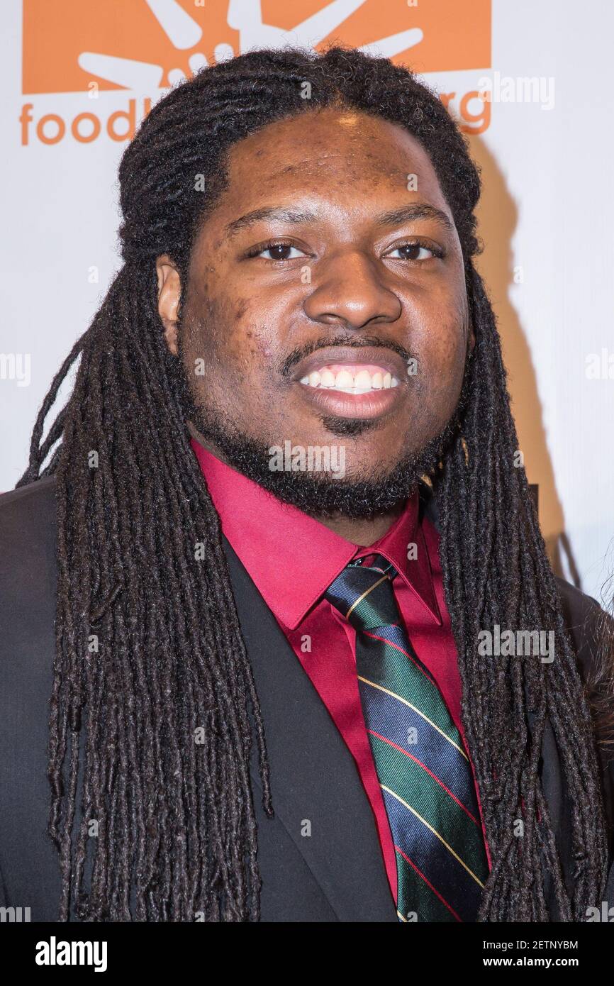 Professional football player Adam Gettis attends the Food Bank for New ...