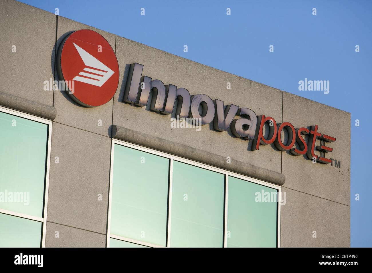 A logo sign outside of a facility occupied by Innovapost in Mississauga ...