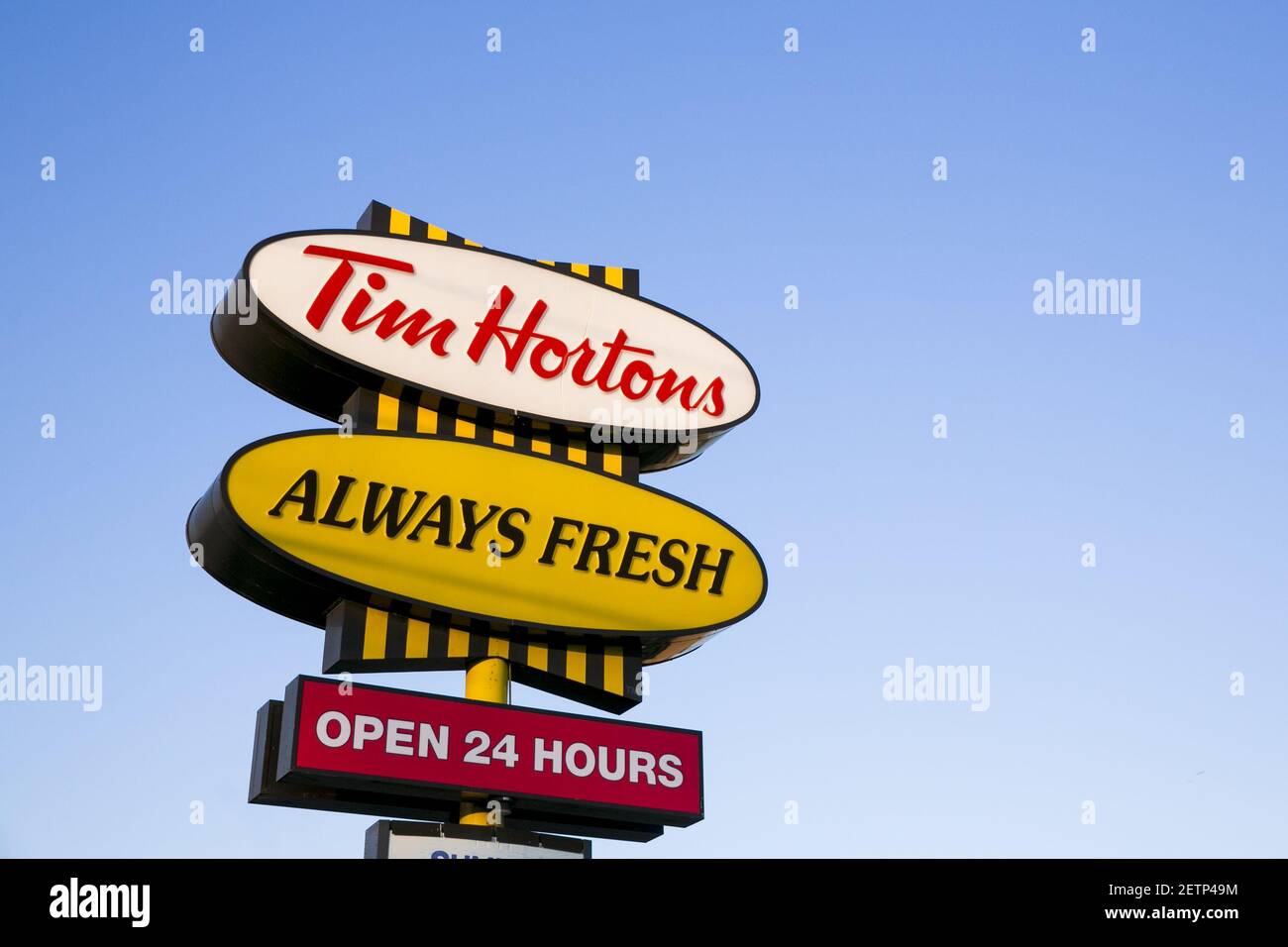 A logo sign outside of a Tim Hortons restaurant in Oakville, ON, Canada ...