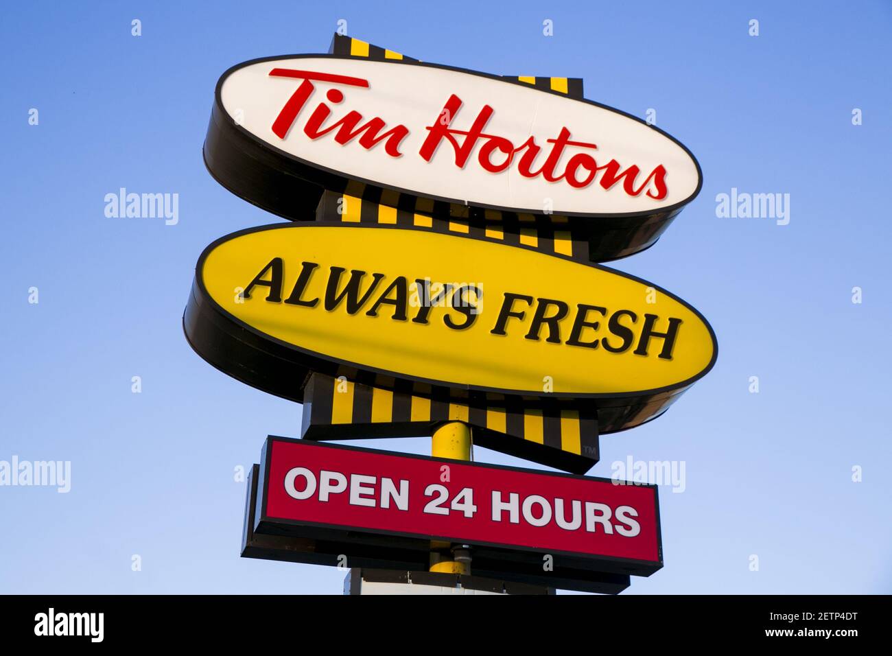 A logo sign outside of a Tim Hortons restaurant in Oakville, ON, Canada ...