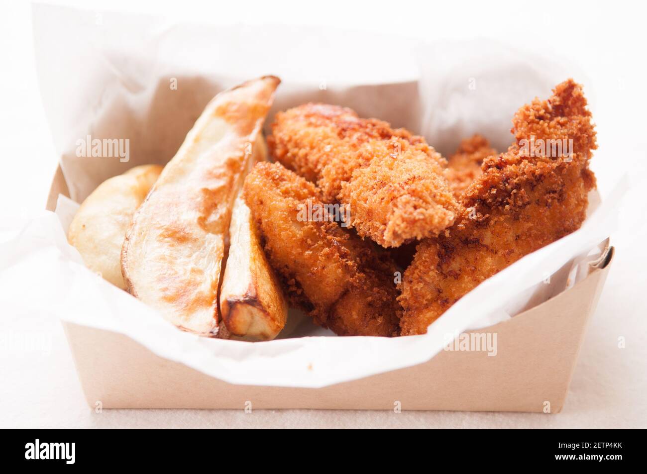 breaded chicken fingers and fries in a take out container Stock Photo ...