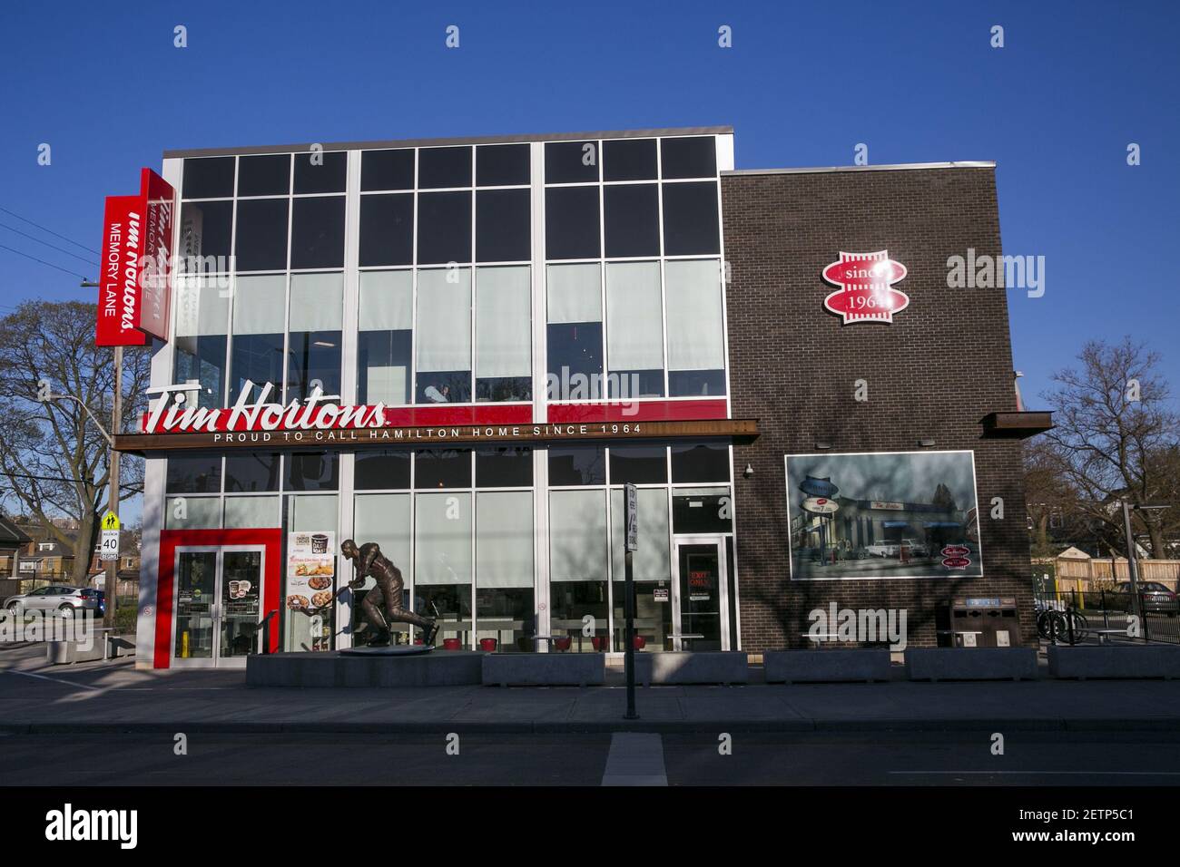 A logo sign outside of the location of the first Tim Hortons restaurant ...