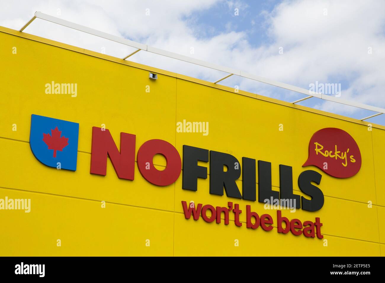 A logo sign outside of a No Frills grocery retail store in Mississauga ...