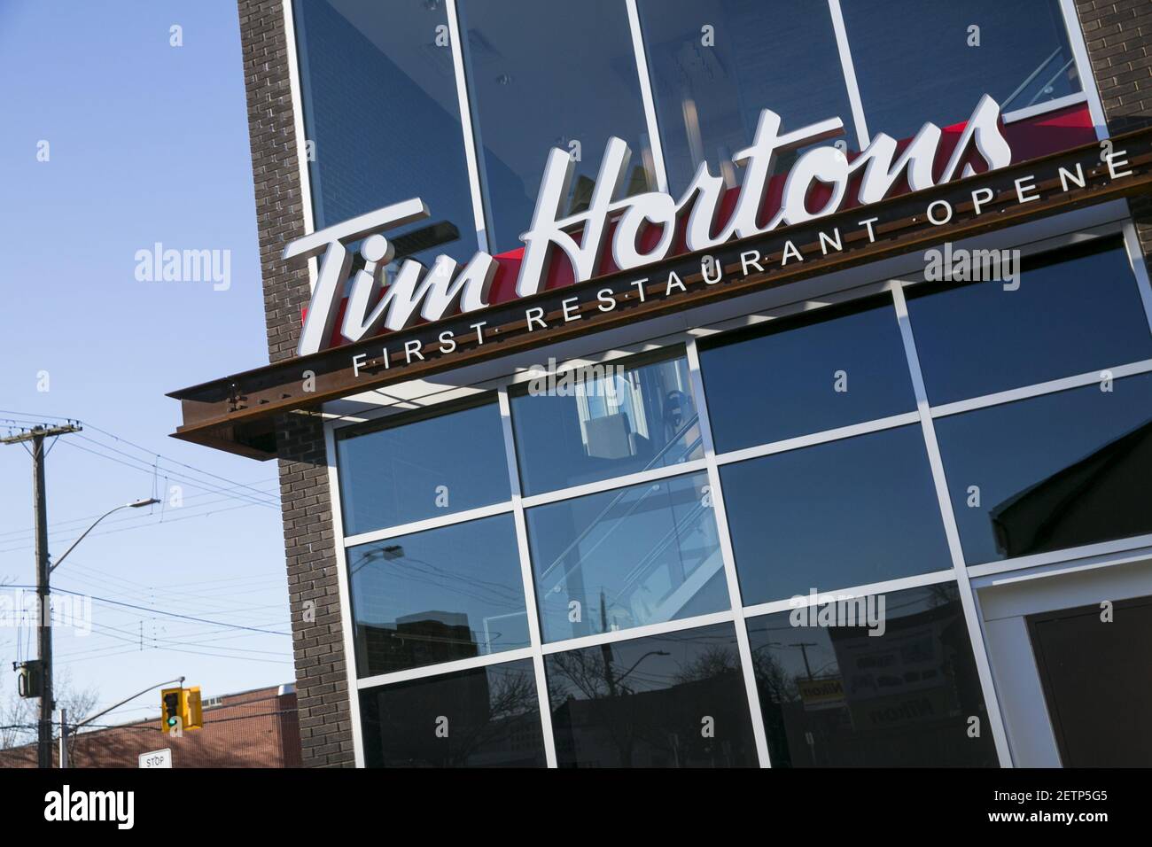 A logo sign outside of the location of the first Tim Hortons restaurant ...