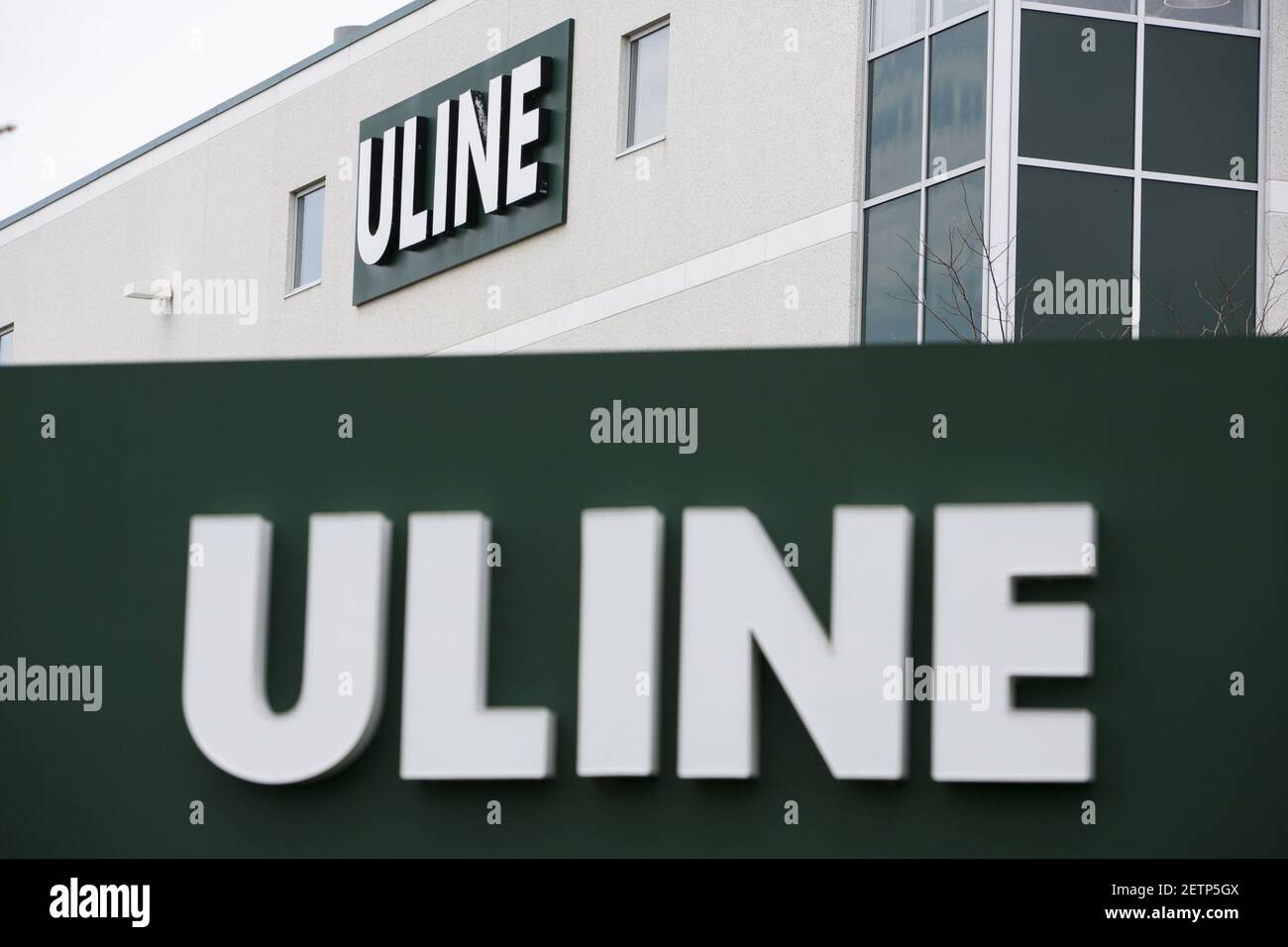 A logo sign outside of facility occupied by Uline in Brampton, Ontario ...