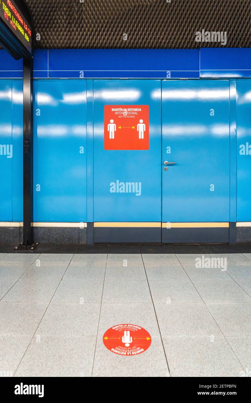 A vertical shot of "Keep the Distance" signs on the floor and doors ...