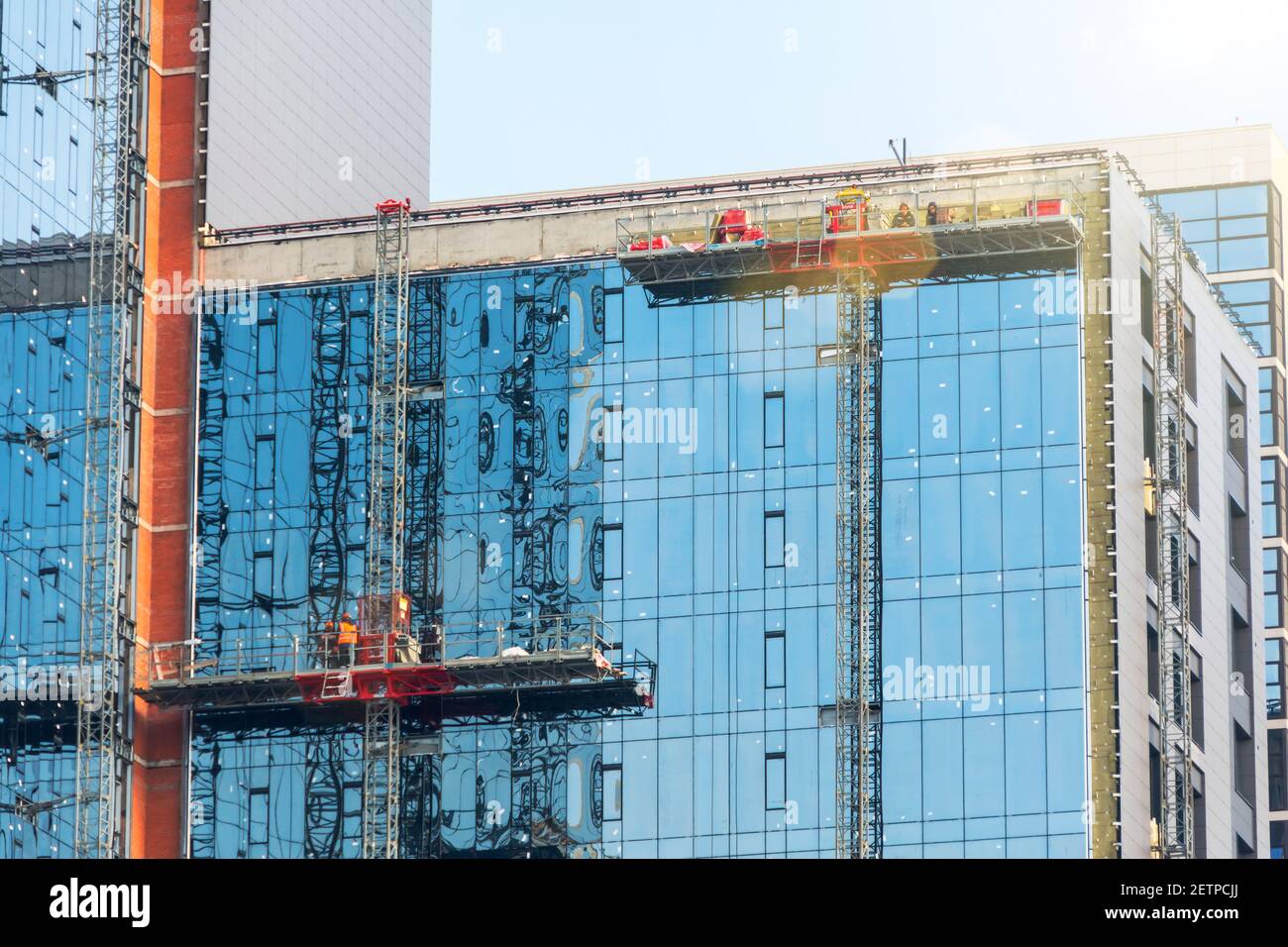 Finishing the facade of residential buildings by workers on the ...