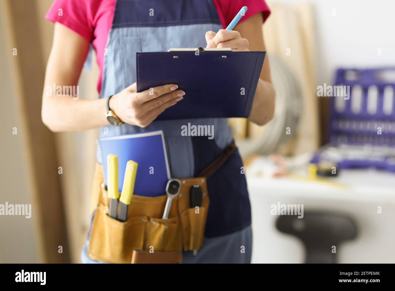Woman repairman writing paper on clipboard closeup Stock Photo - Alamy