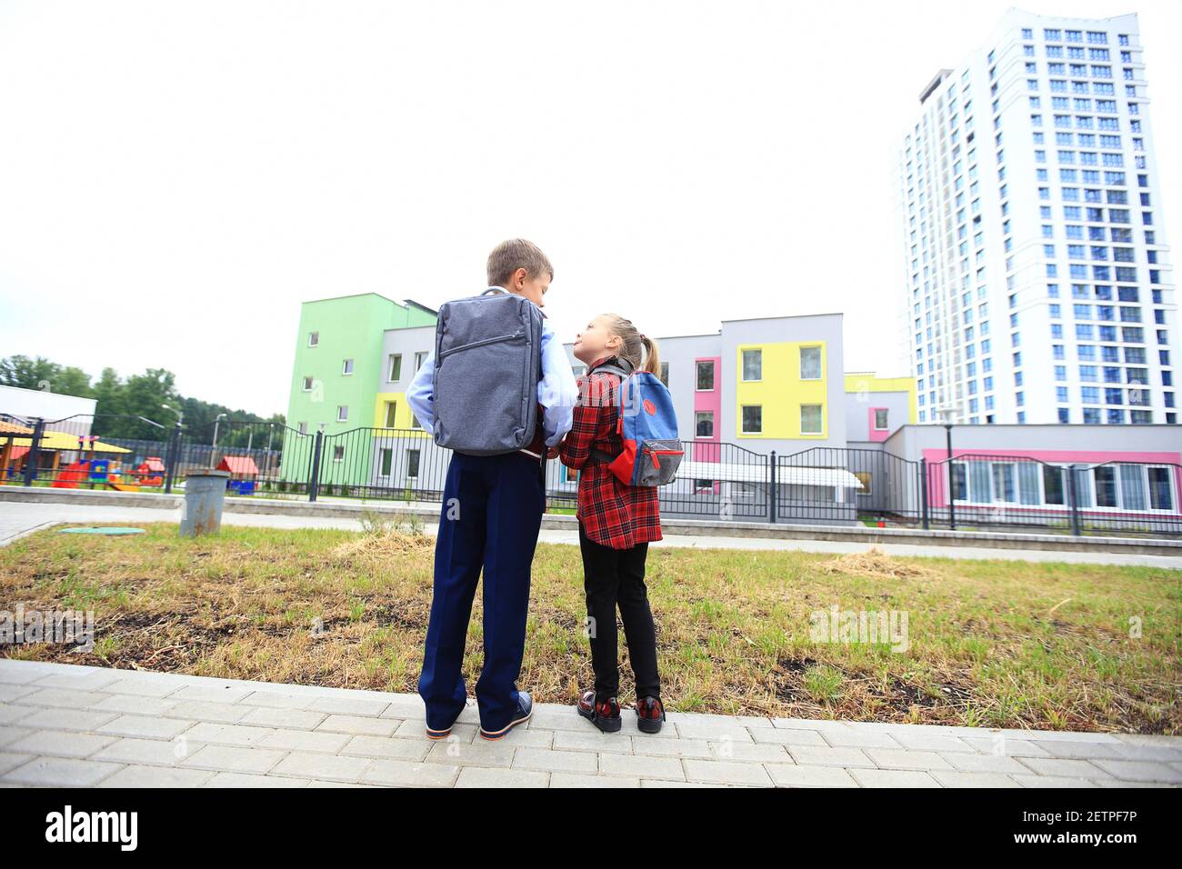 Children with briefcases over their shoulders on the background of the ...