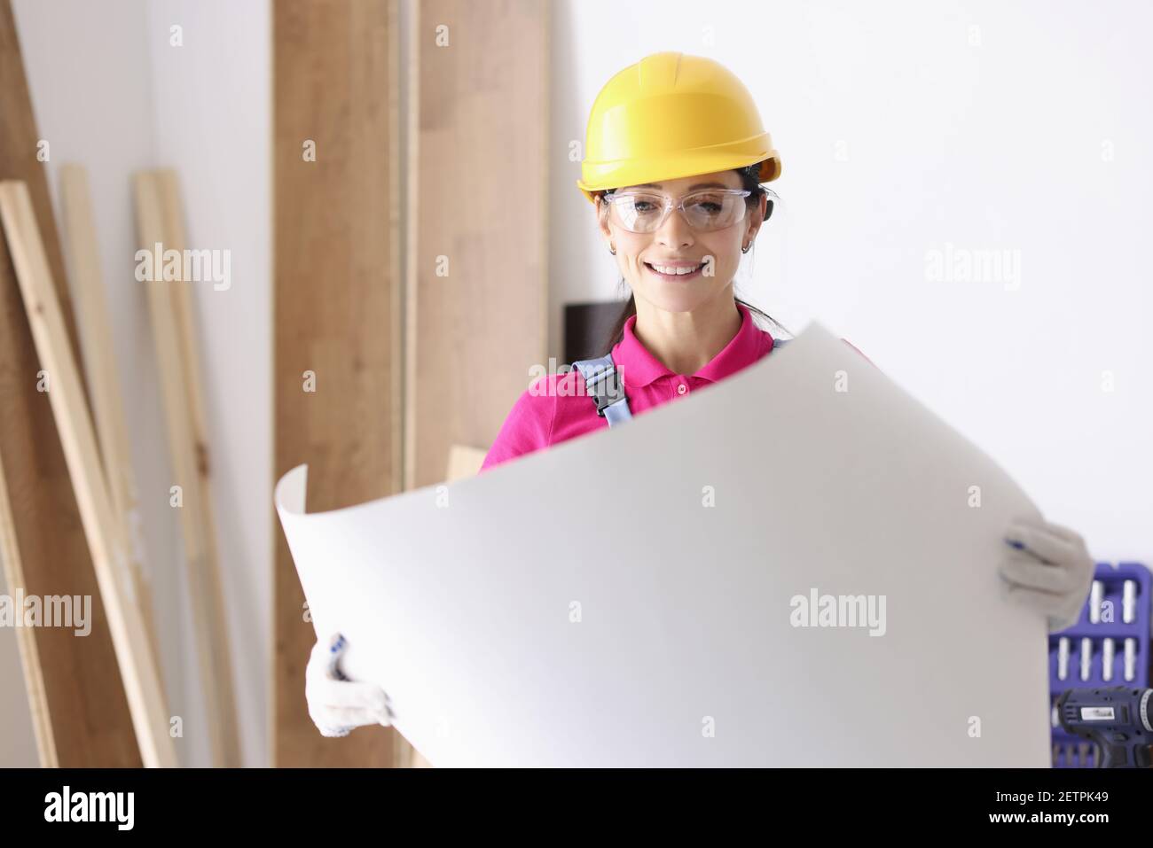 Woman architect holding building construction project in hands Stock ...