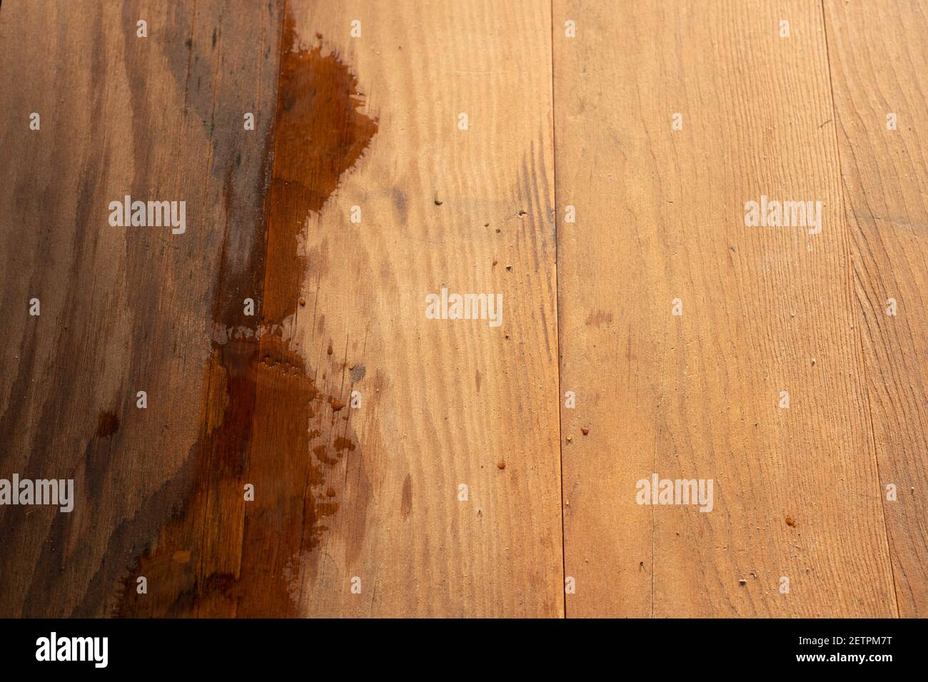 Natural wooden table with water on it. Water leak Stock Photo - Alamy