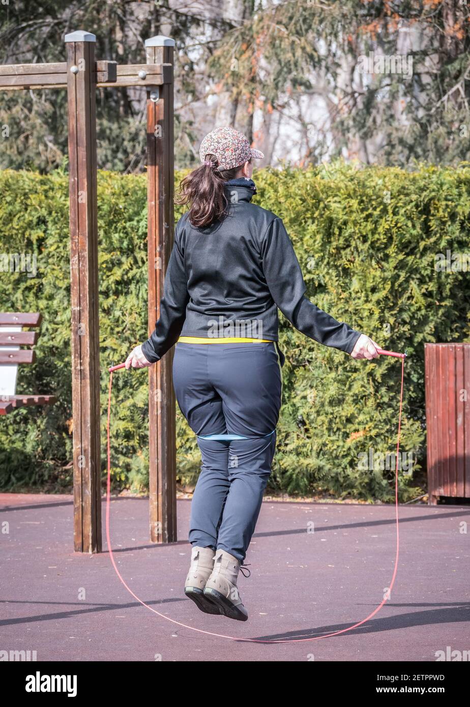 Girl in the park training with jump rope Stock Photo - Alamy