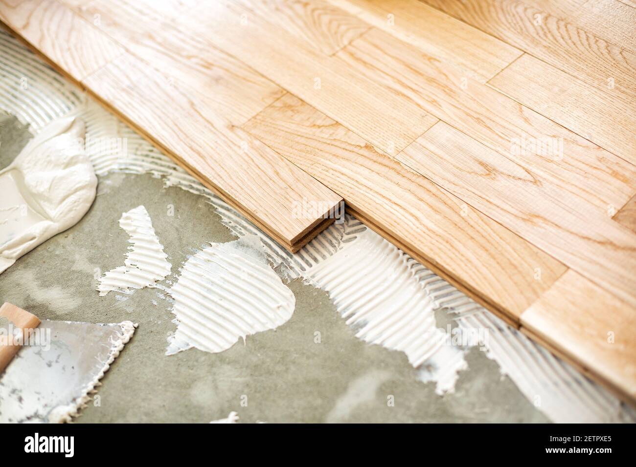 Skilled worker preparing the subfloor base using a hand tool Stock ...