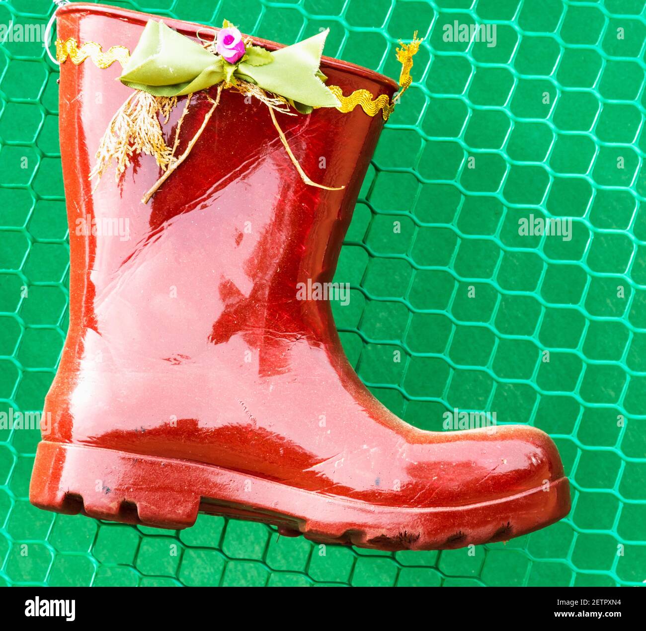 A decorated rubber boot hanging on iron fence Stock Photo - Alamy