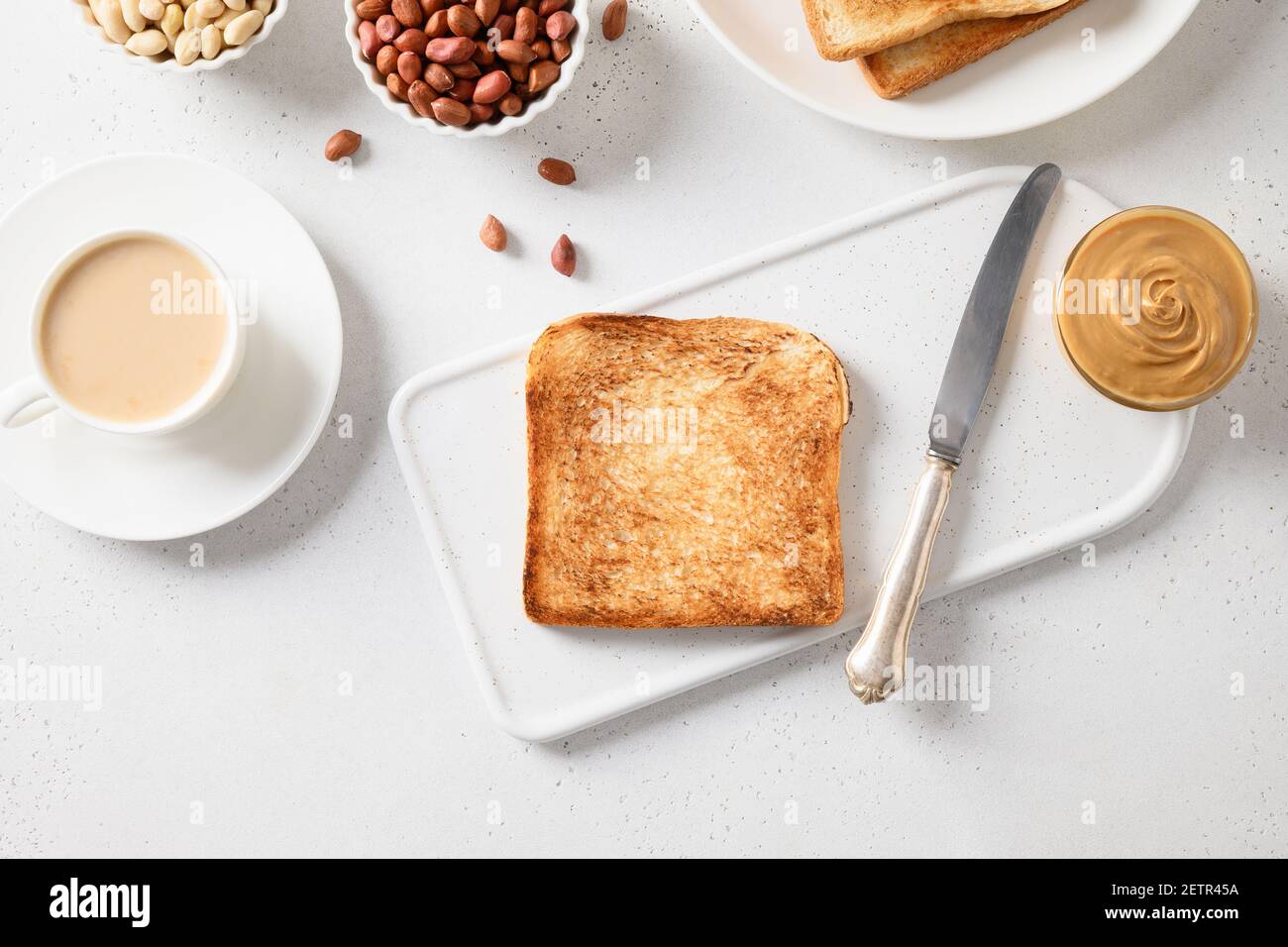 Breakfast with coffee and crispy toast with peanut paste on white ...