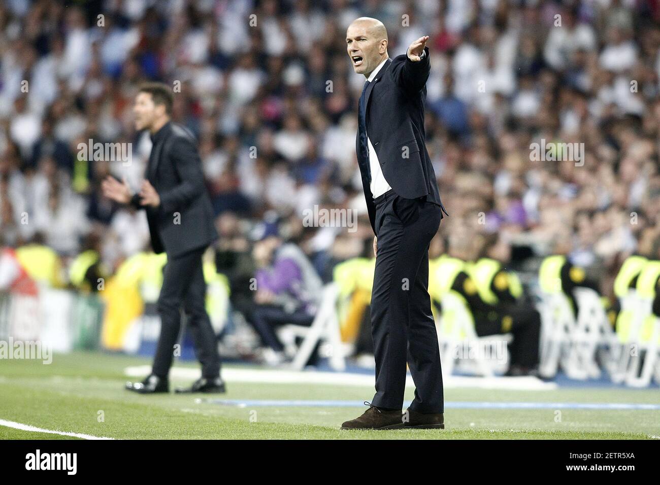 Real Madrid's coach Zinedine Zidane (r) and Ataletico de Madrid's coach ...