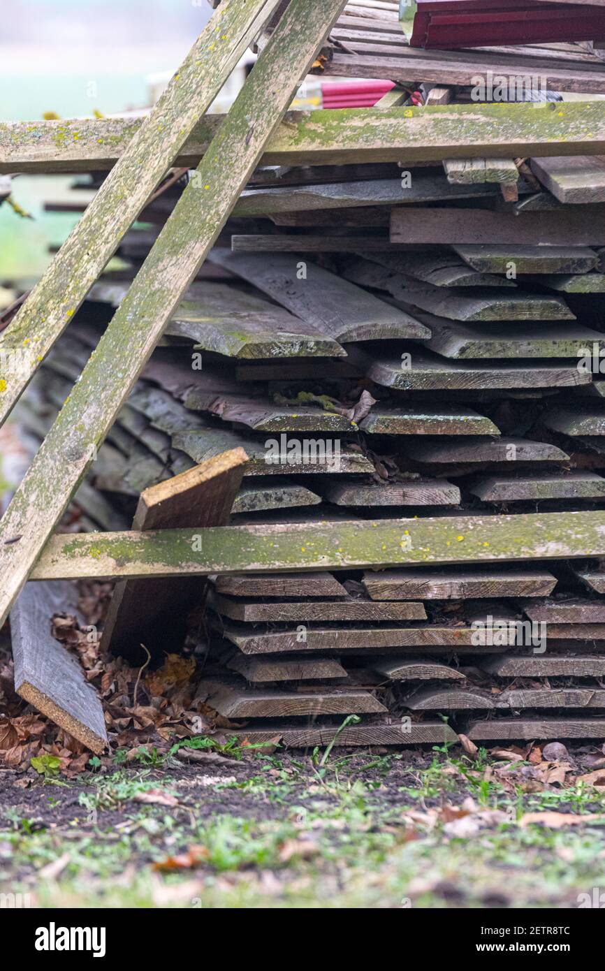 A pile of boards has been standing for a long time. Improperly stored ...