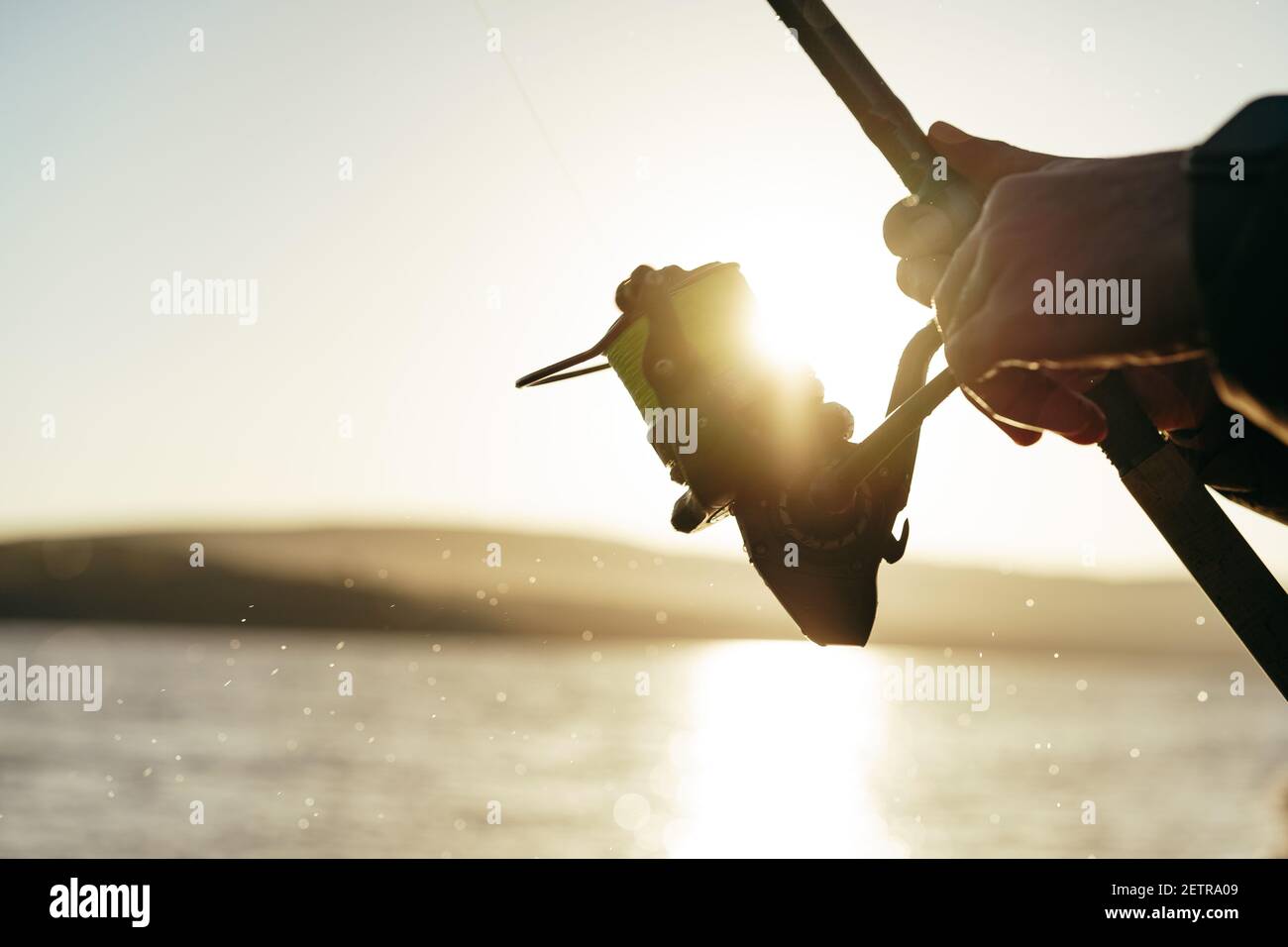 Fisherman hands holding fishing rod close up Stock Photo - Alamy