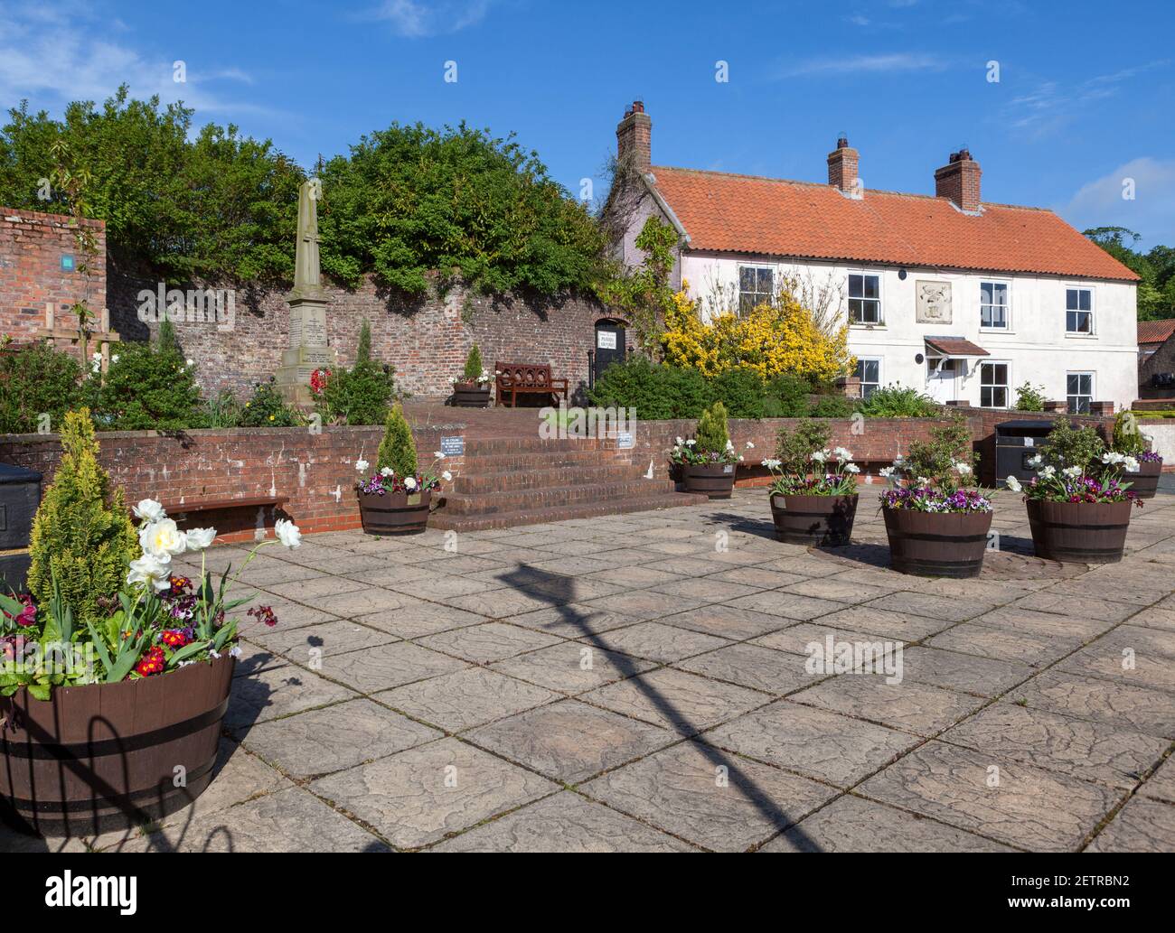 the attractive flower lined square and war memorial at Hunmanby in ...