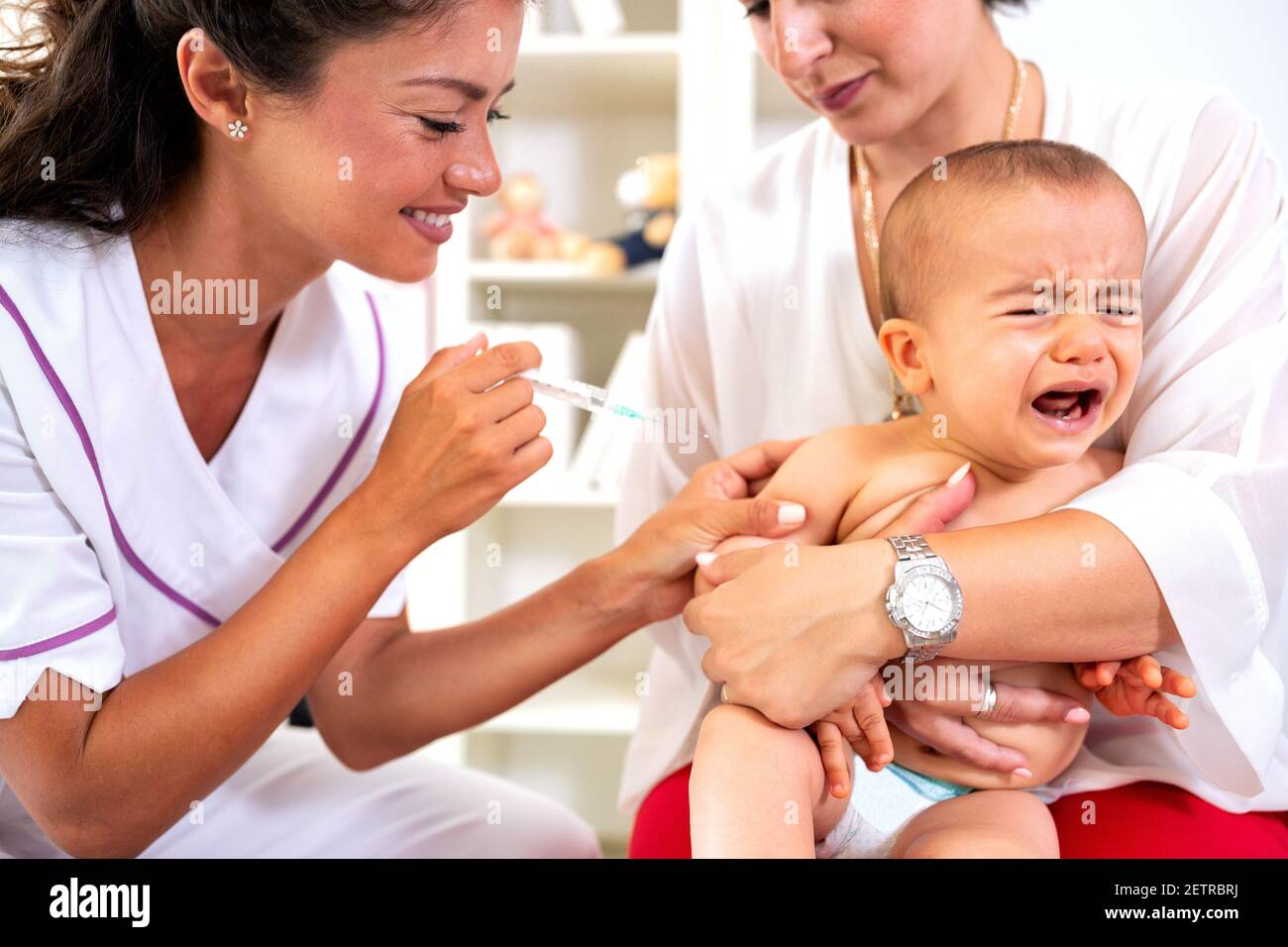 Little boy receiving a vaccine shot with disapproval expression on his ...