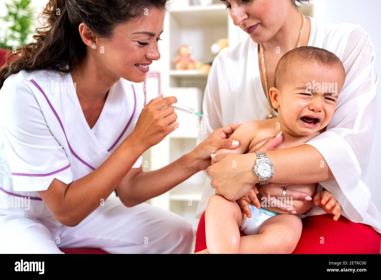 Little boy receiving a vaccine shot with disapproval expression on his ...