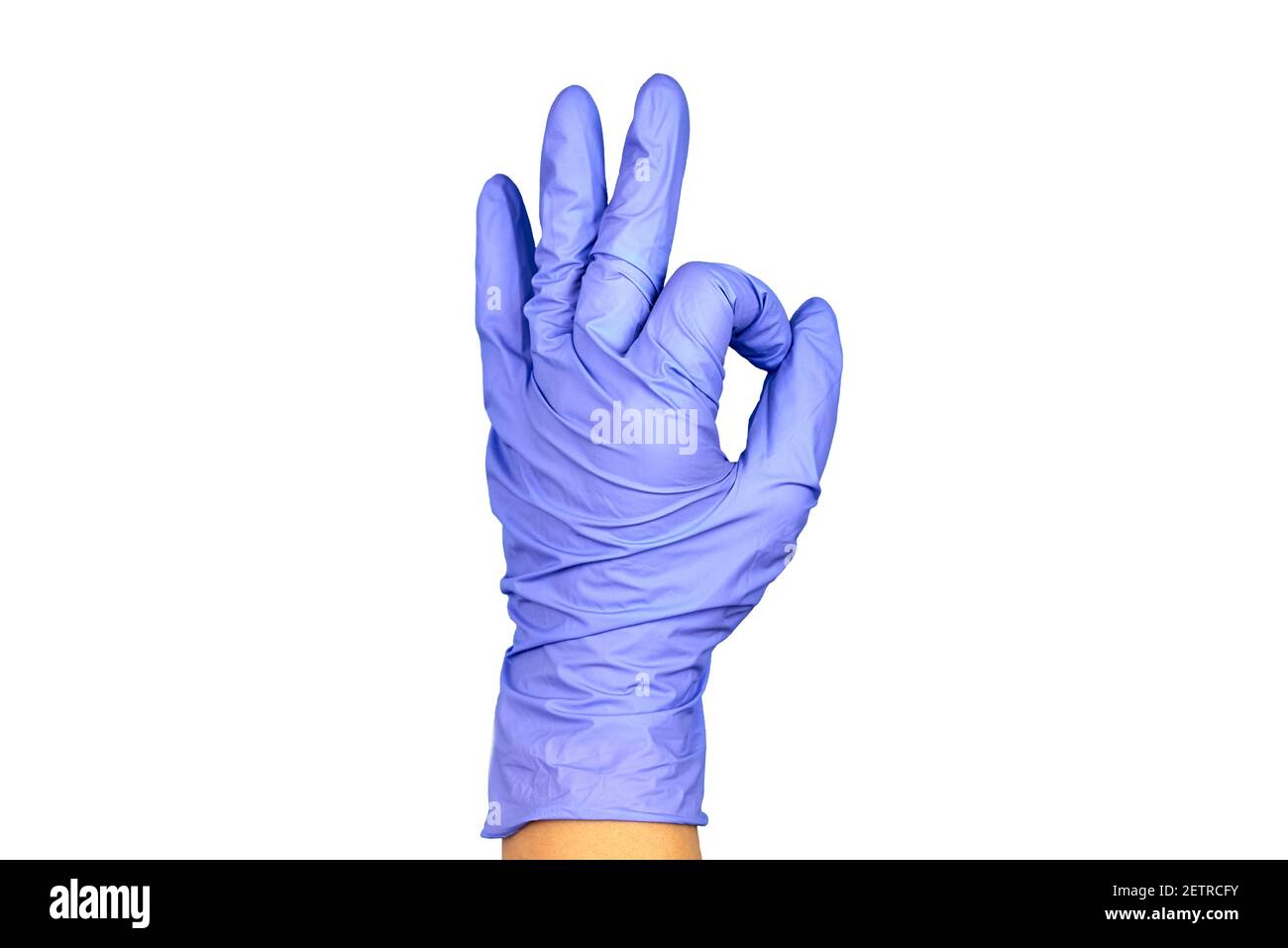 Woman's hand in a medical glove shows a gesture ok isolated on white ...