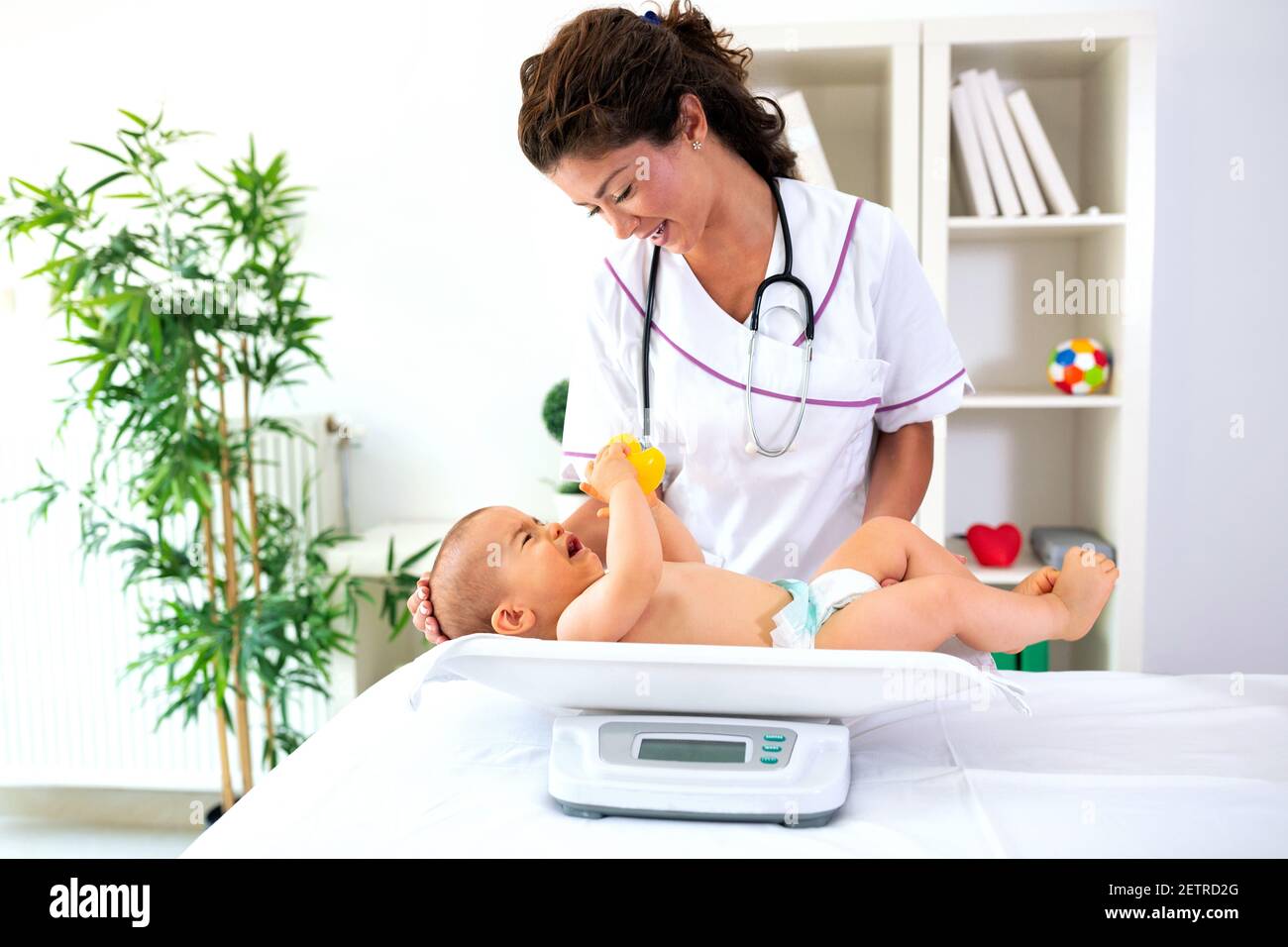 Child specialist making an assessment of a baby’s growth progress Stock ...