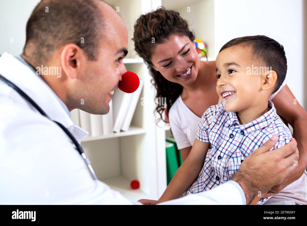 Funny doctor entertaining a little kid while wearing a clown nose Stock ...