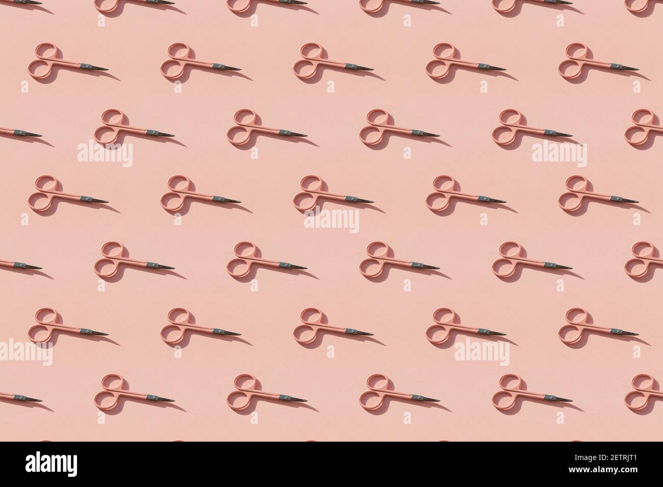 Cosmetic scissors on pink background Stock Photo - Alamy