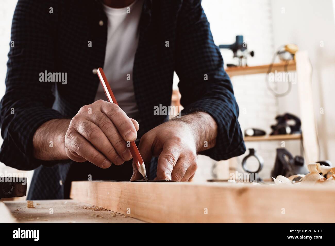Carpenter makes pencil marks on a wood plank Stock Photo - Alamy