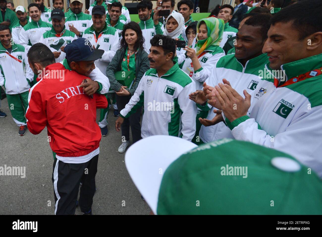 A Pakistani athlete dances with a Syrian athlete, during Athletes ...
