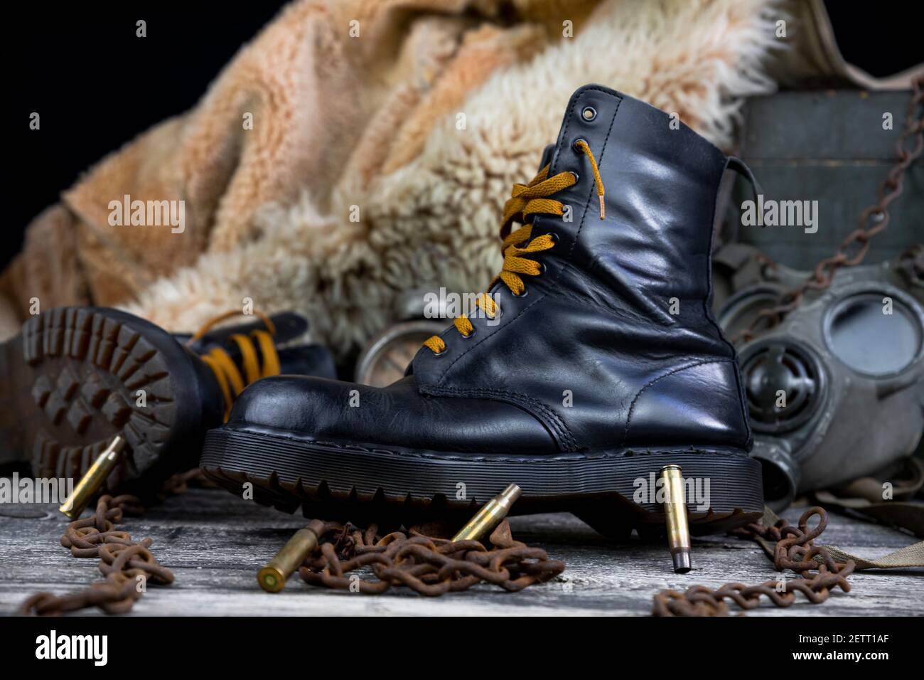 Leather boots with rusted chains and bullet shells with military gas ...