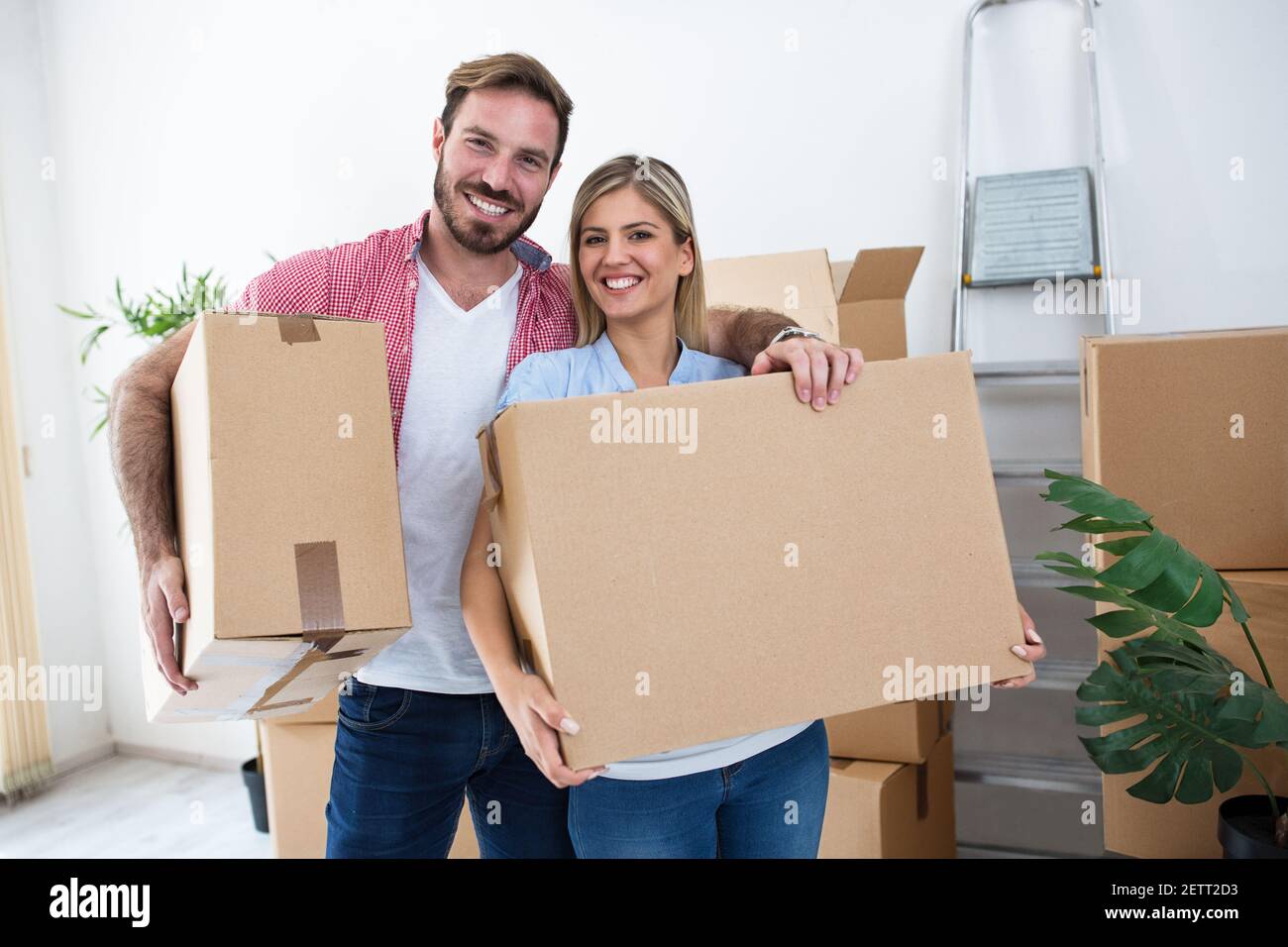 Young couple packing boxes for moving to a new home Stock Photo - Alamy