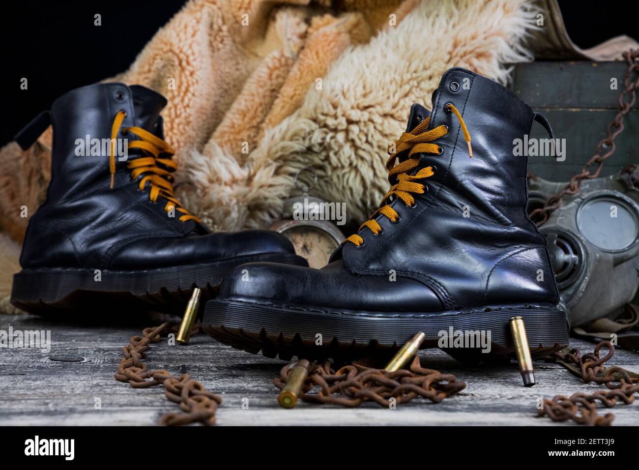 Leather boots with rusted chains and bullet shells with military gas ...