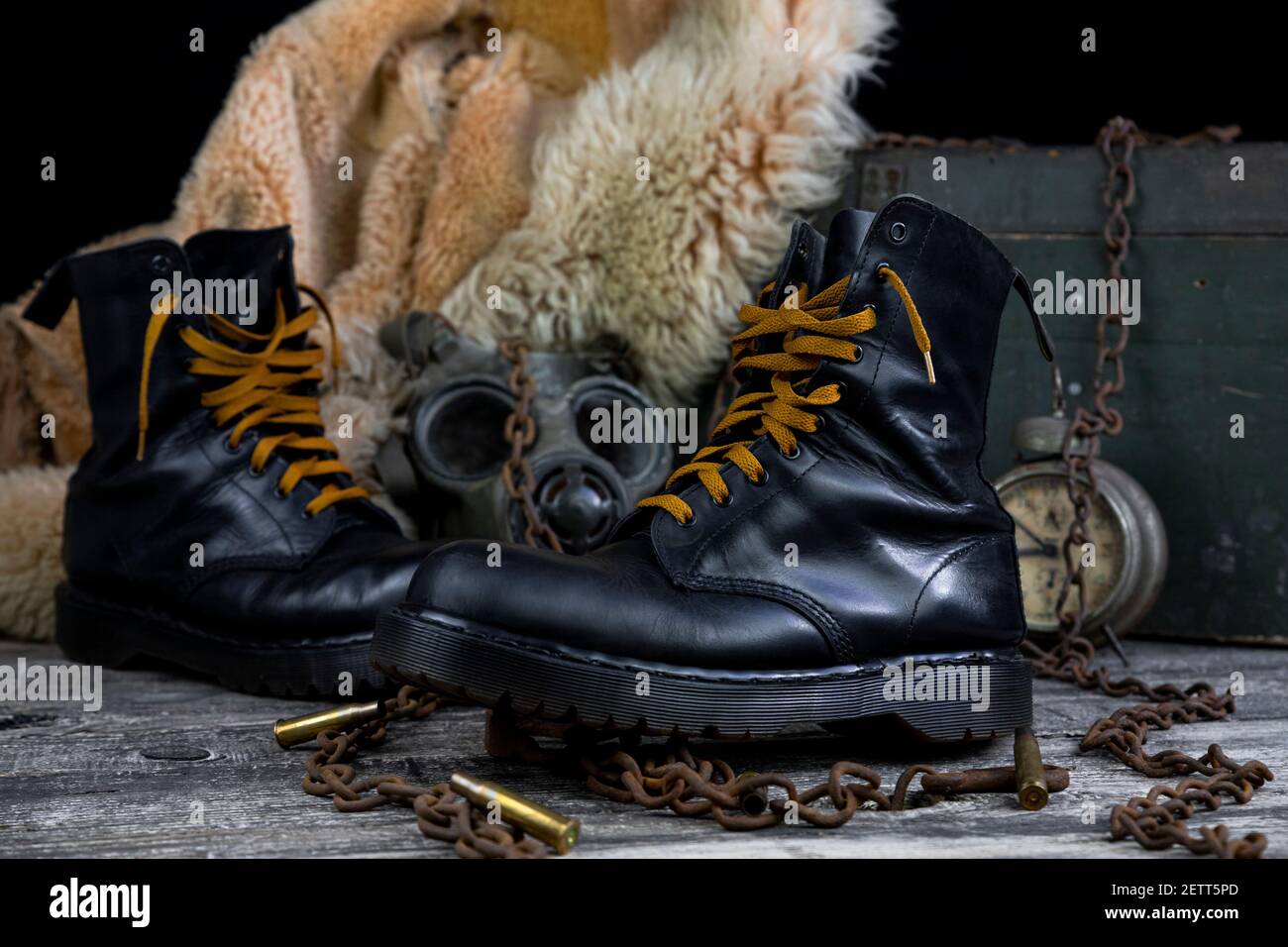Leather boots with rusted chains and bullet shells with military gas ...