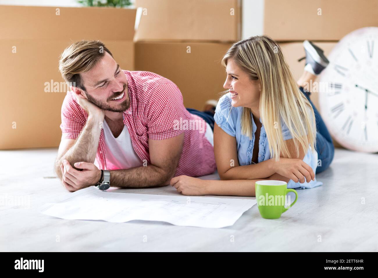 Young couple making plan about there new home, layout of rooms at new ...