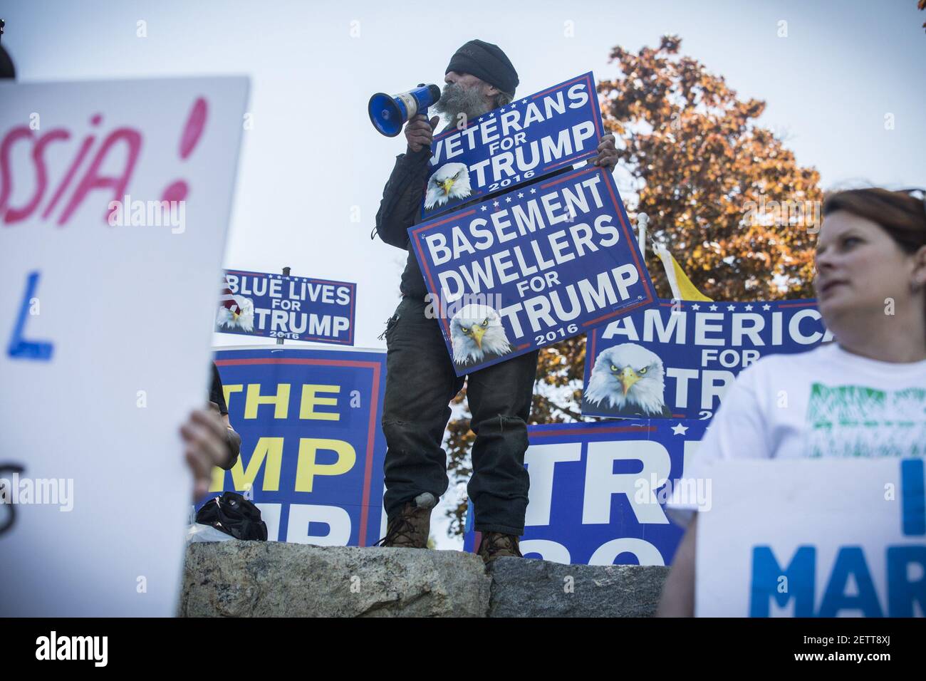 A Trump supporter uses a megaphone to talk to the crowd of supporters ...