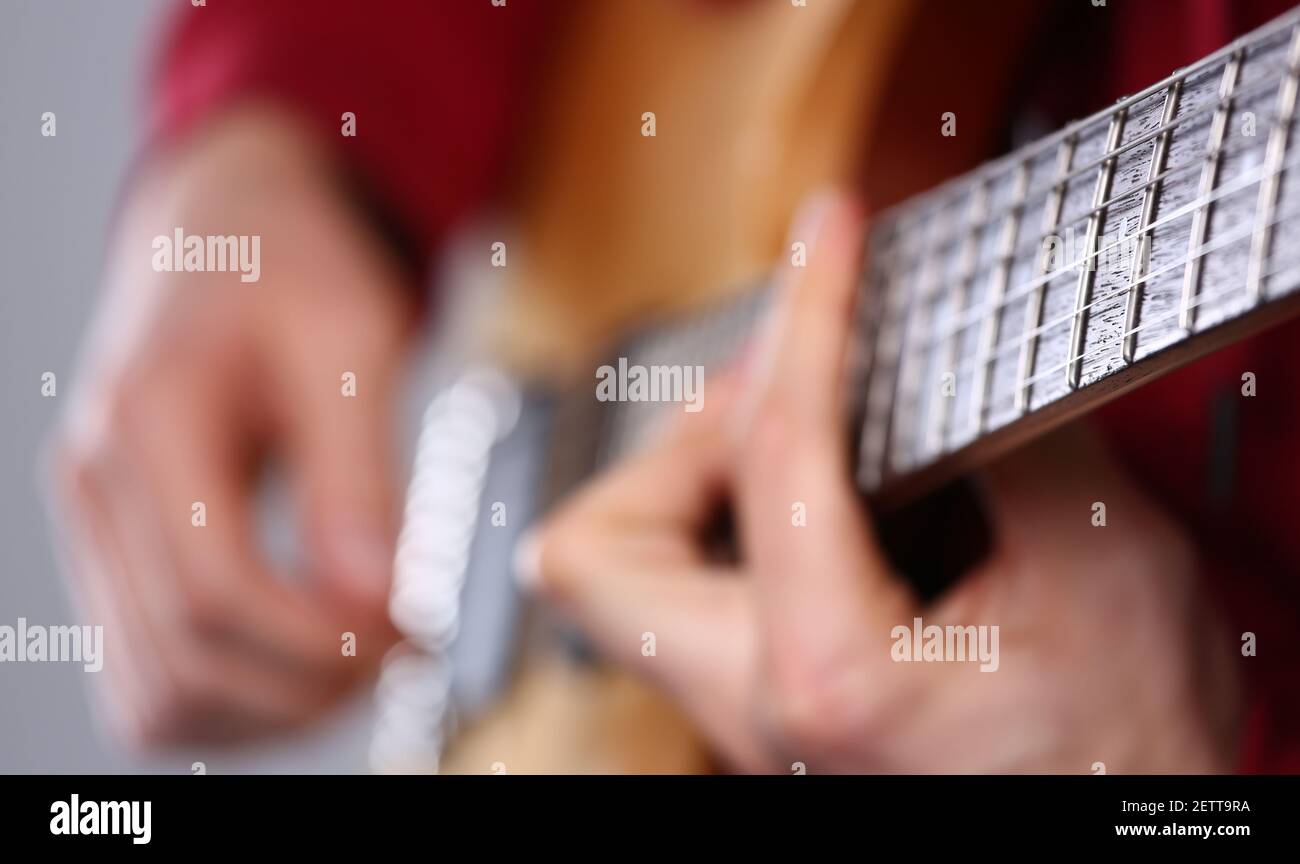 Man playing musical instrument guitar closeup Stock Photo - Alamy