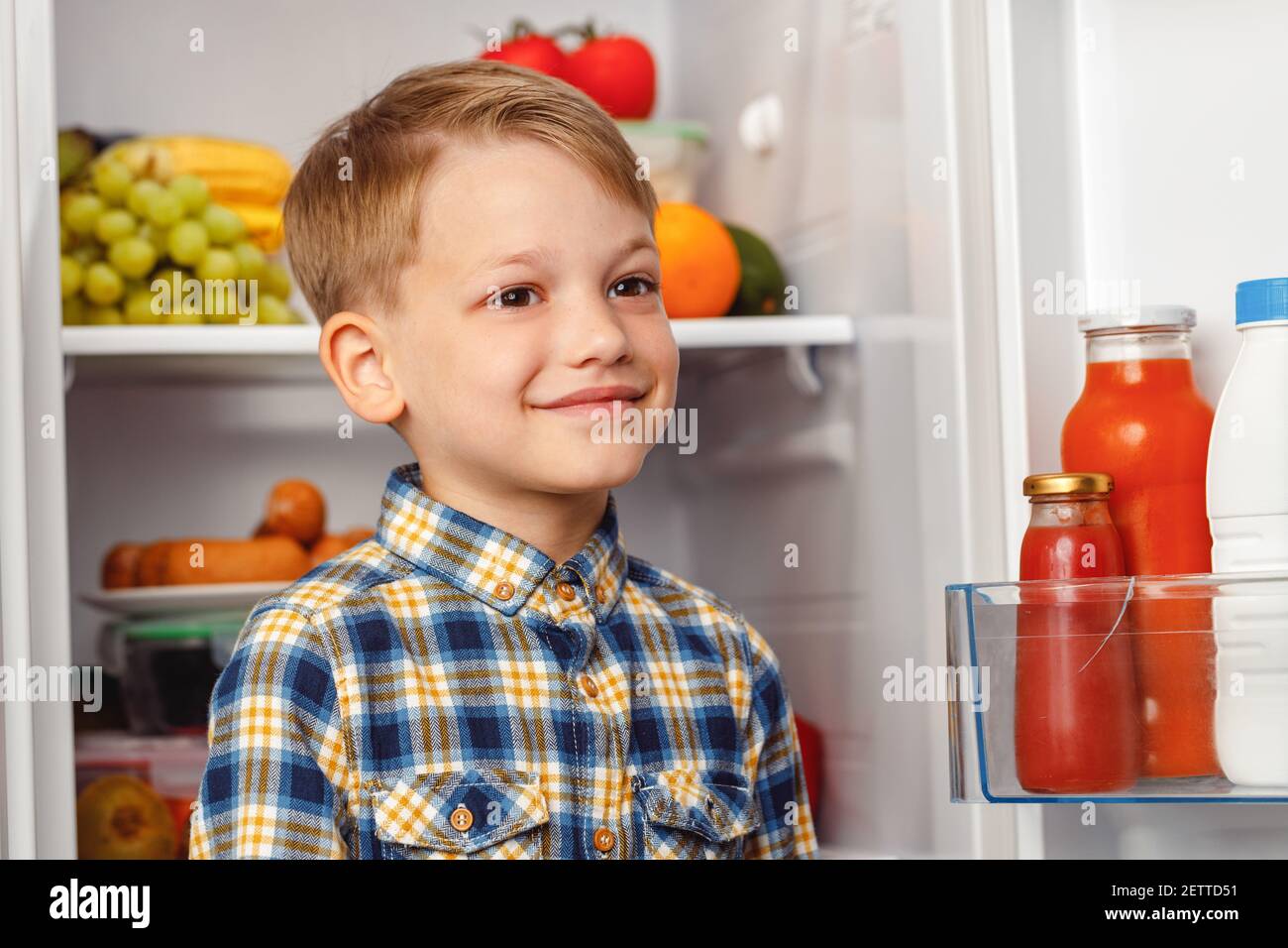 Little boy standing near the open fridge Stock Photo - Alamy