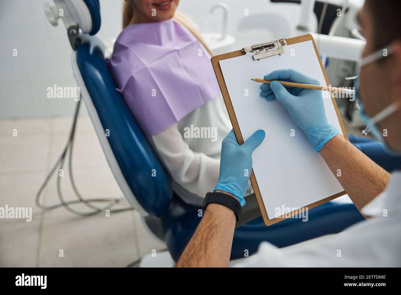 Pencil in doctor hand over a white page Stock Photo - Alamy