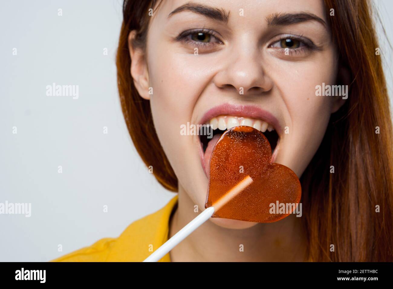 Pretty woman licking heart hi-res stock photography and images - Alamy