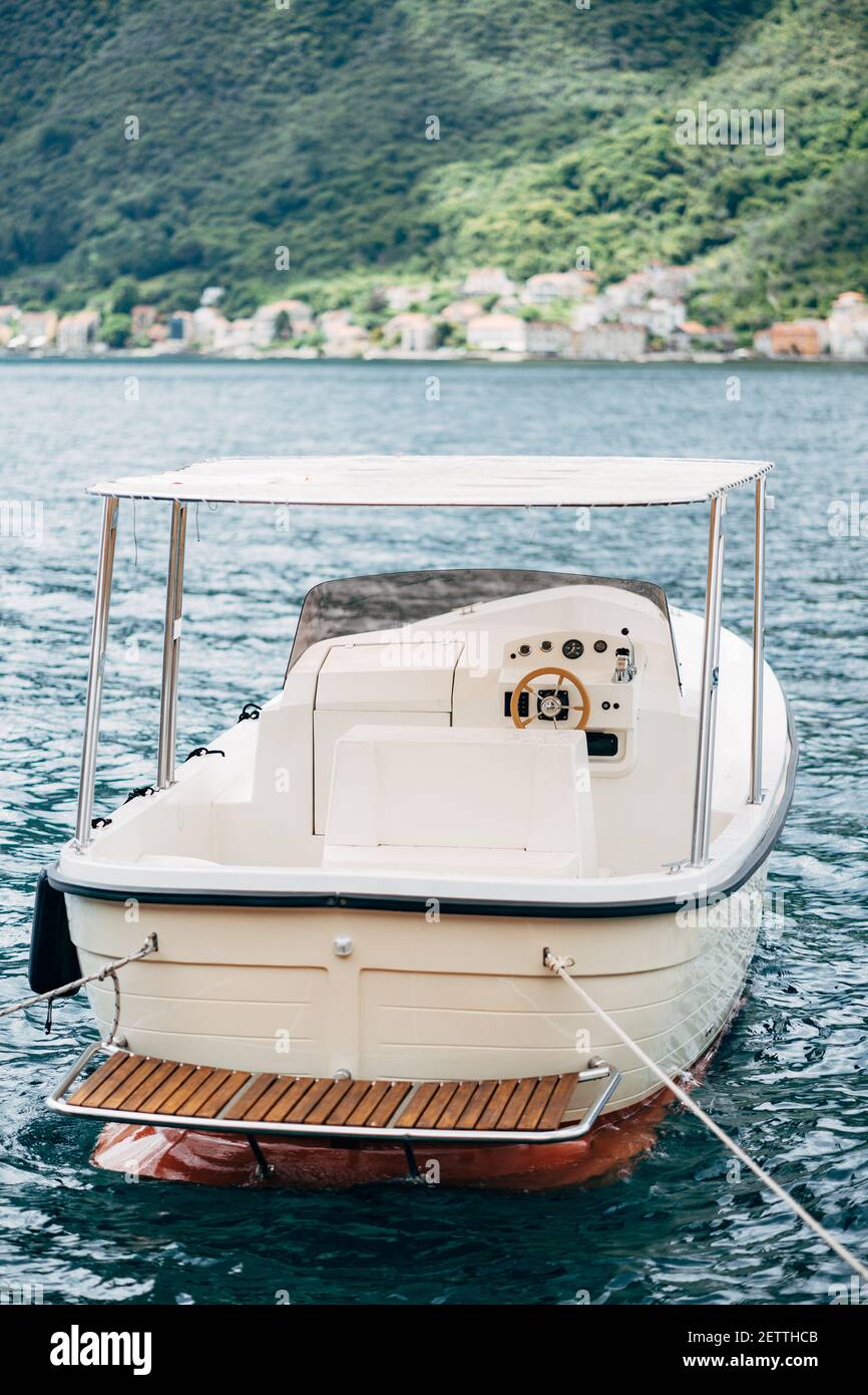White pleasure boat with awning, rear view. Moored in the water Stock ...