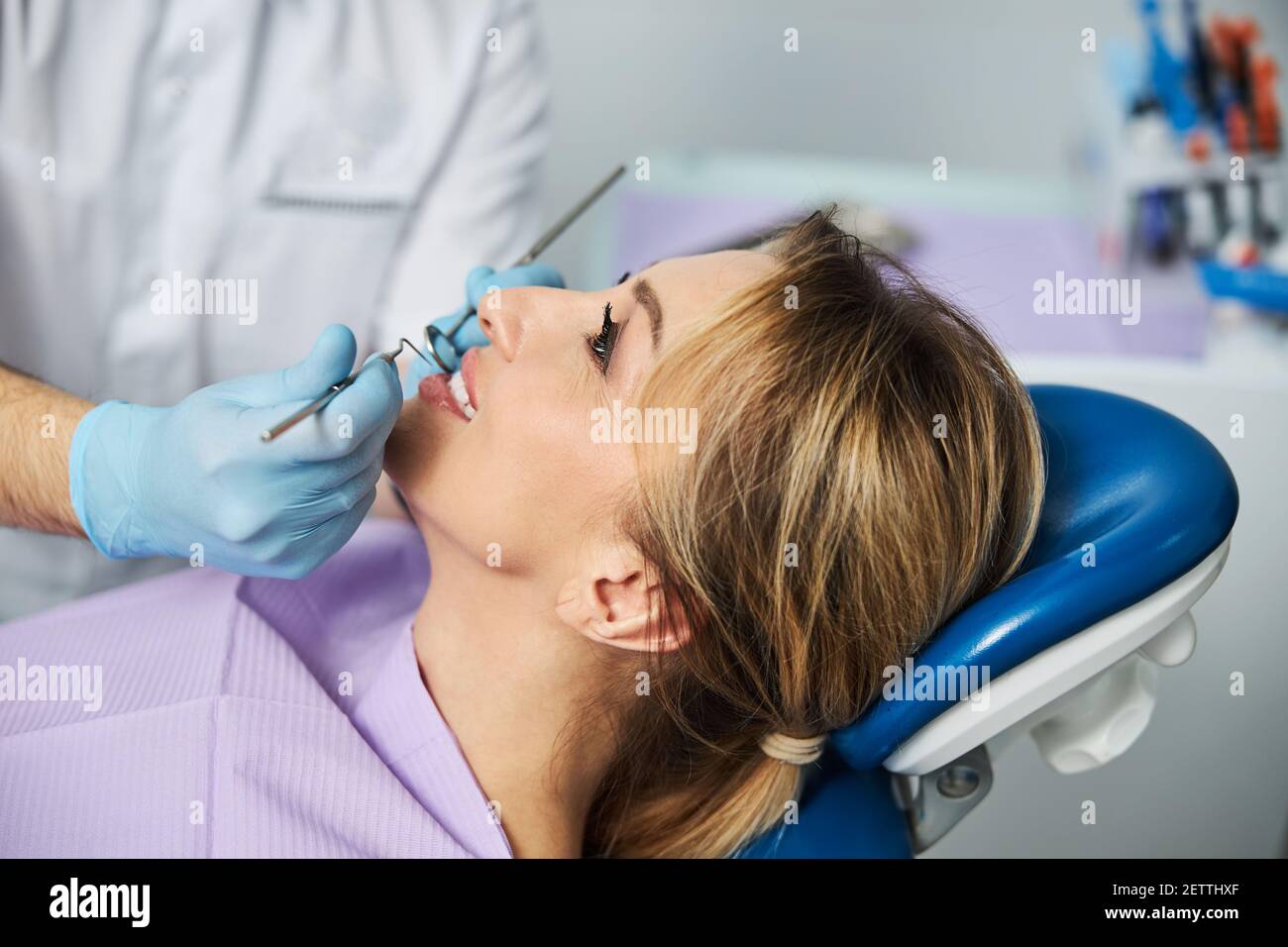 Stomatologist performing a check of teeth with dental tools Stock Photo ...