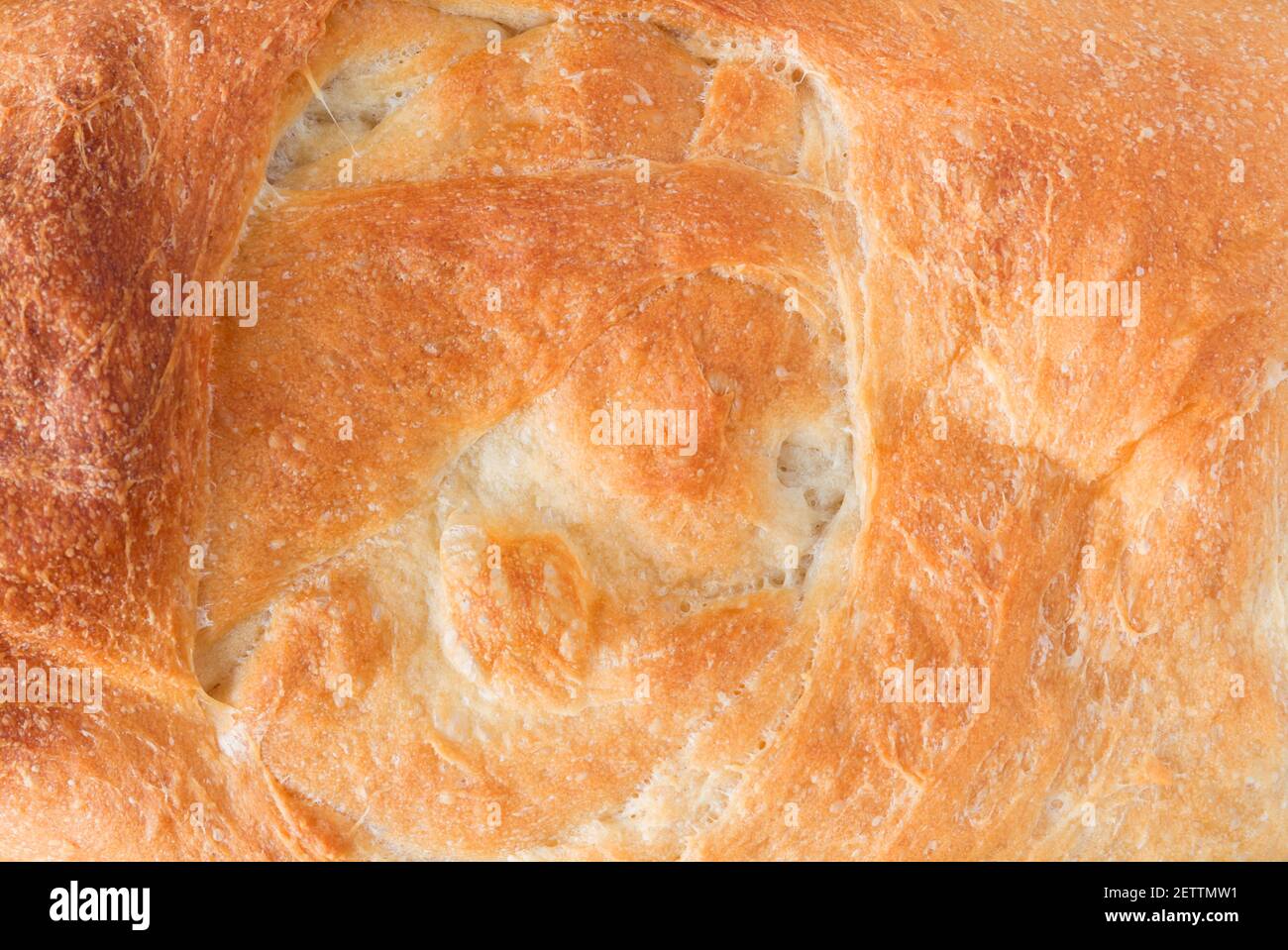 Top close view of the crust of a baked loaf of homemade bread ...