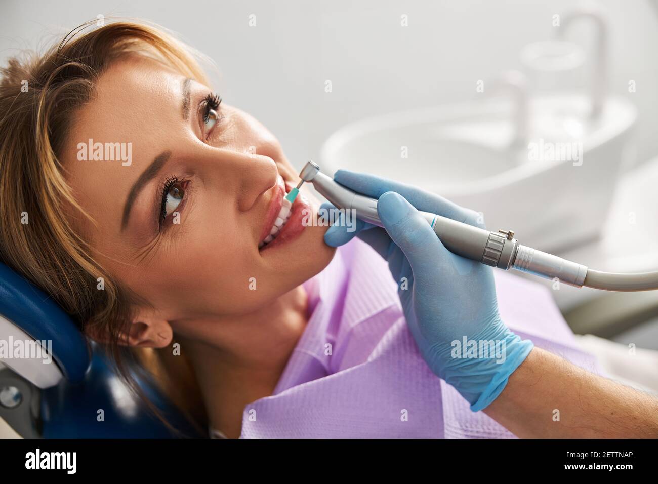 Pretty woman under a tooth polishing procedure Stock Photo - Alamy
