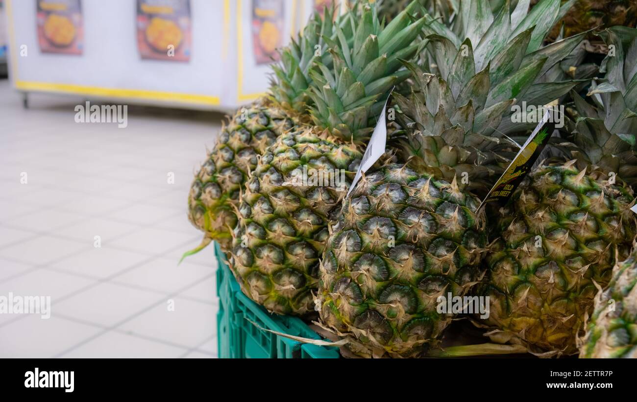pineapple for sale in the market aisle Stock Photo - Alamy