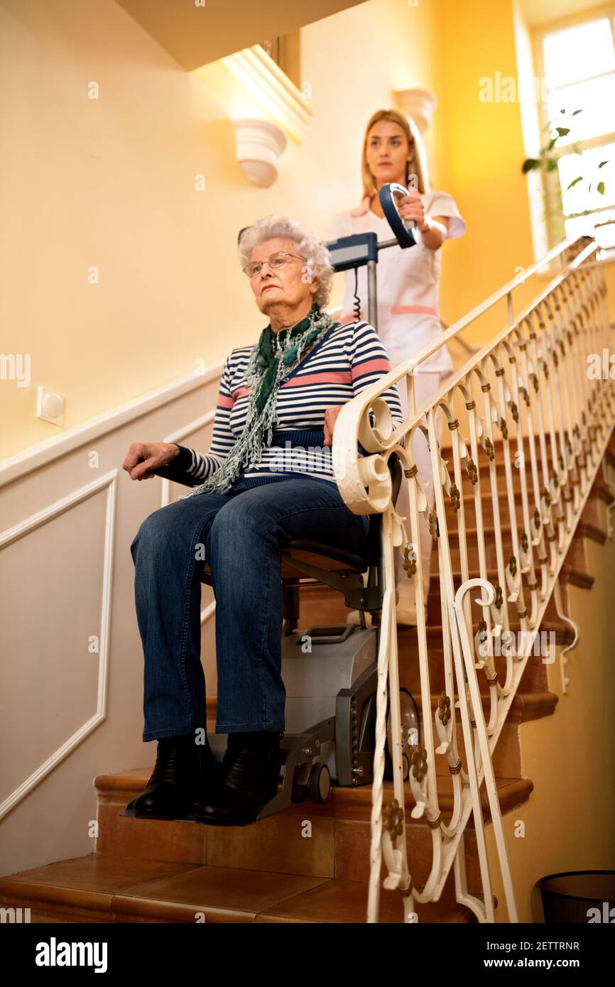 Mature woman climbing stairs hi-res stock photography and images - Alamy